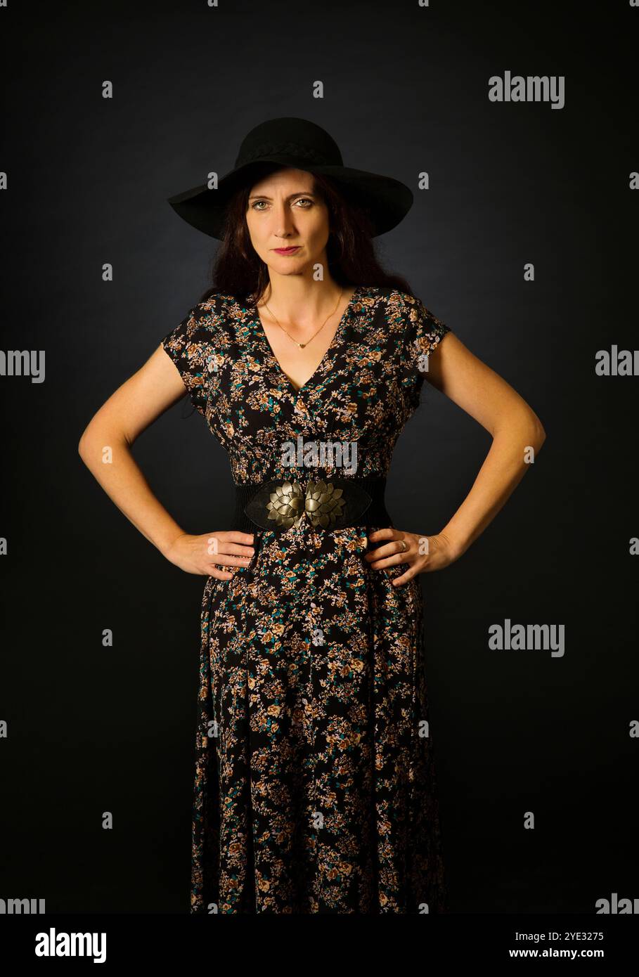 sturn looking women with her hands on her hips Stock Photo - Alamy