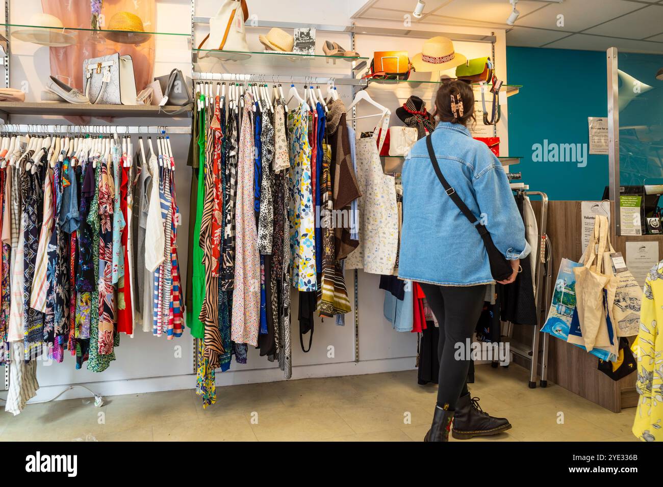 A customer browsing inside a charity shop in Truro in Cornwall in the ...