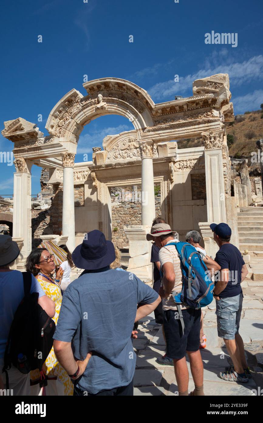 Group of visitors listening to tour guide at the Temple of Hadrian in ...