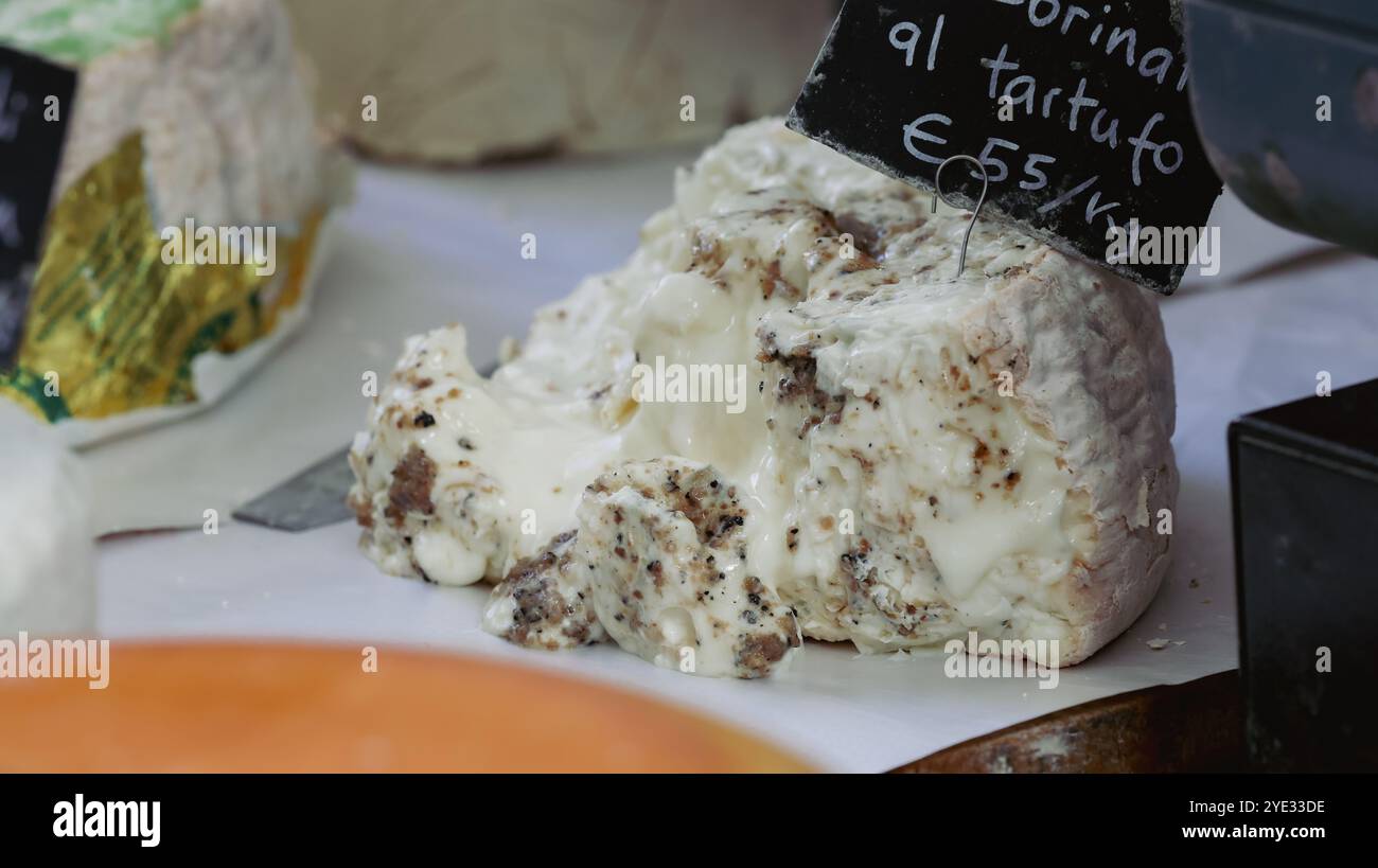 A creamy truffle cheese sits on display at a market in Alba, Italy ...