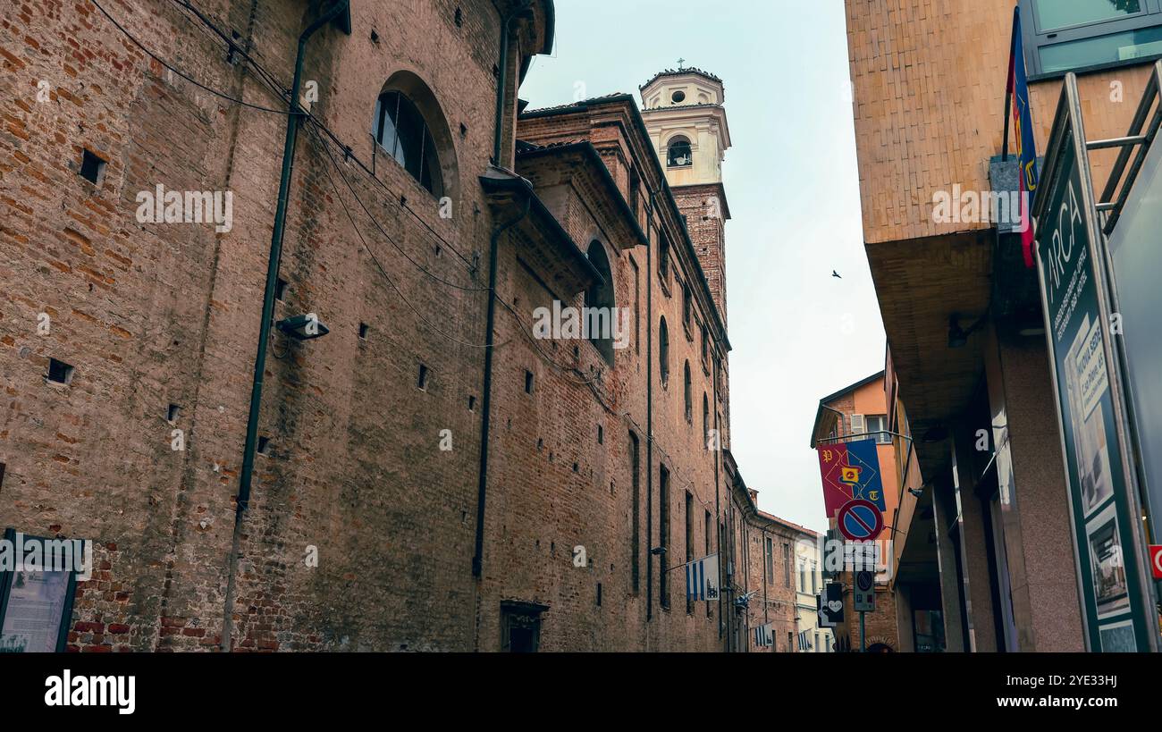 Wander through the narrow streets of Alba, Italy, lined with old brick ...