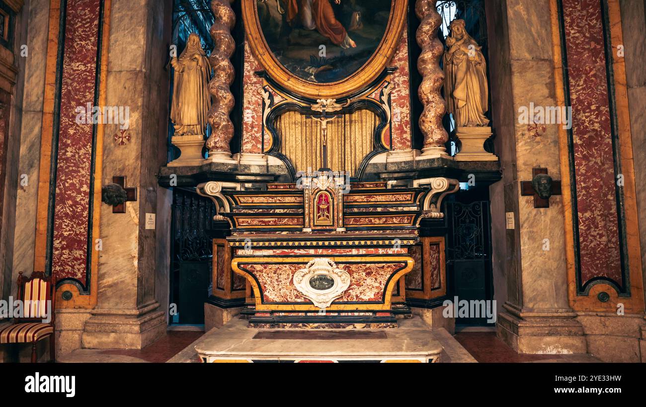 An ornate altar can be seen in a historic church in Alba, Italy. The ...