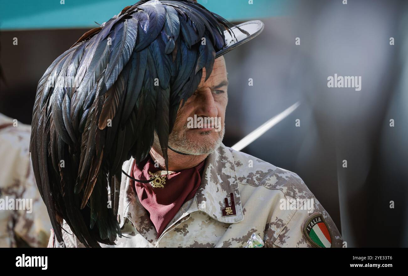 A soldier stands in Alba, Italy, sporting a distinctive feathered ...