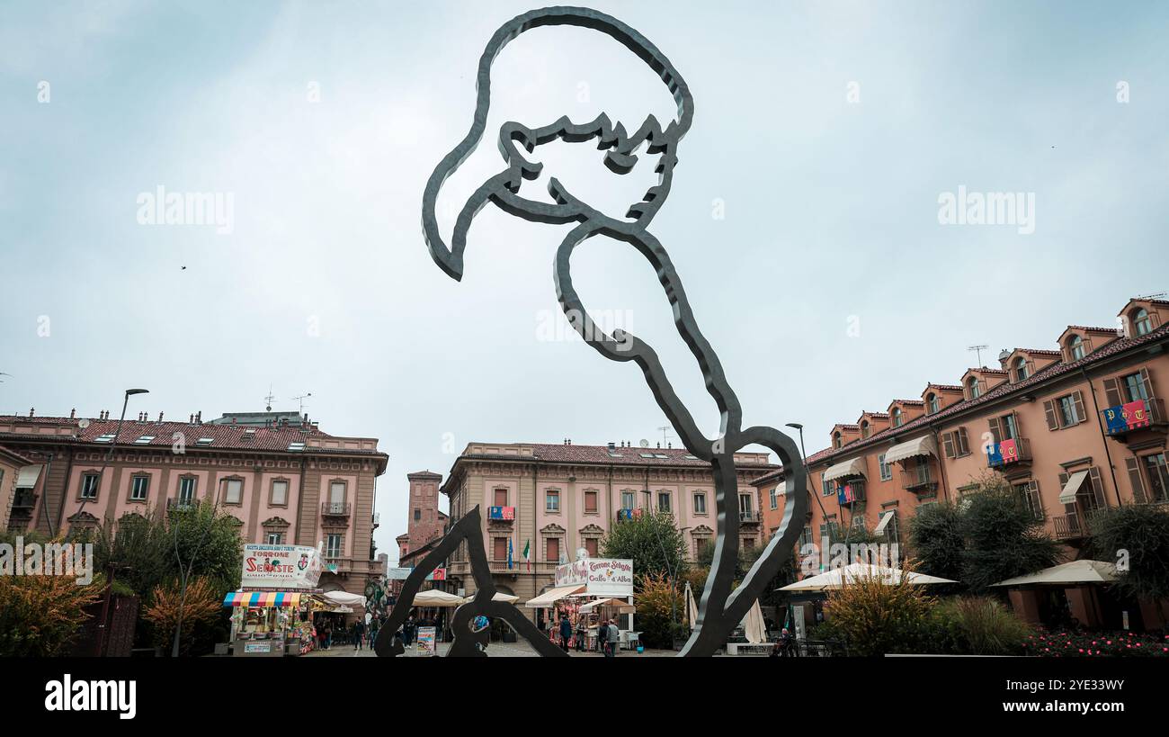 A large metal sculpture of a girl stands prominently in a bustling ...