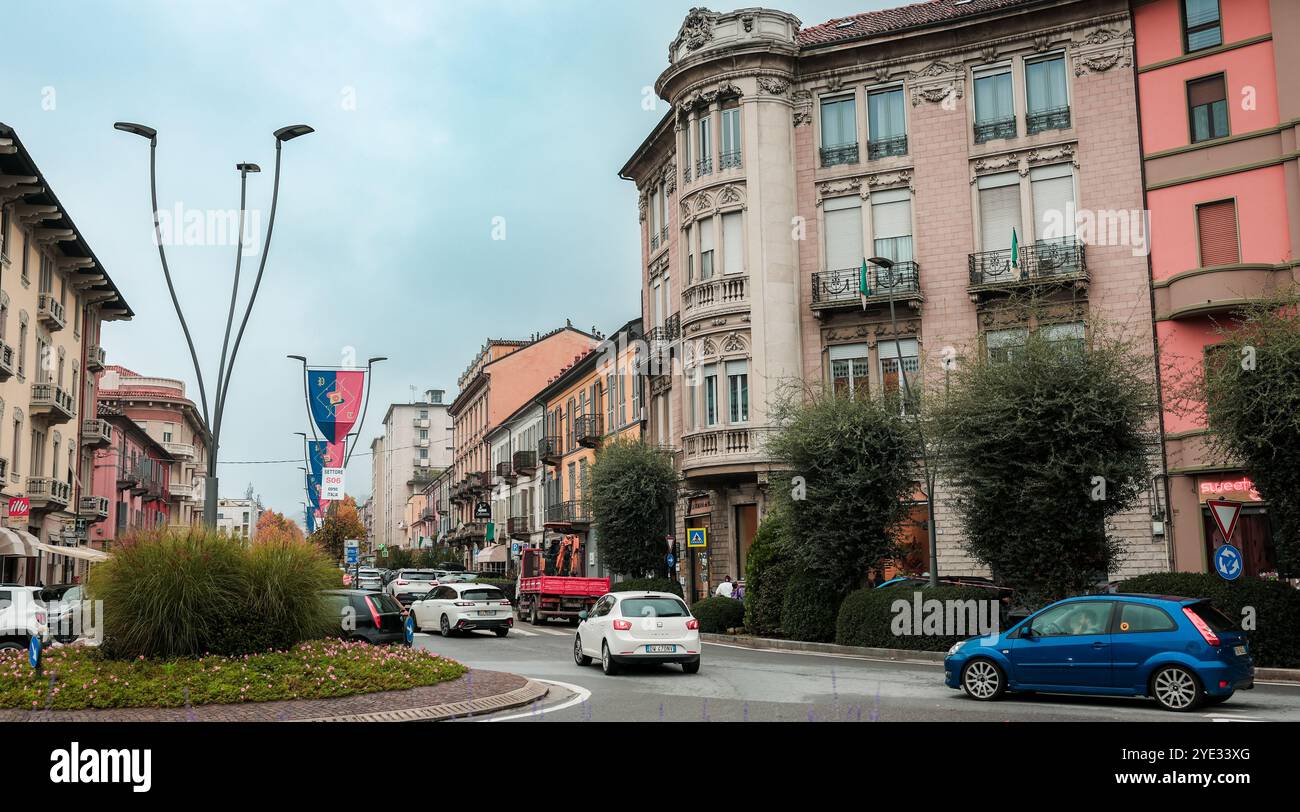 A lively street in Alba Italy shows elegant historic buildings nestled ...