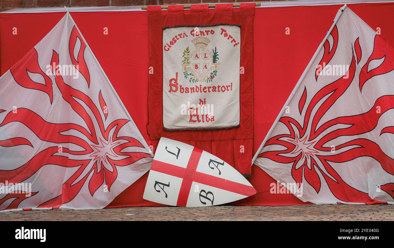 In Alba, Italy, colorful flags and a shield are prominently displayed ...