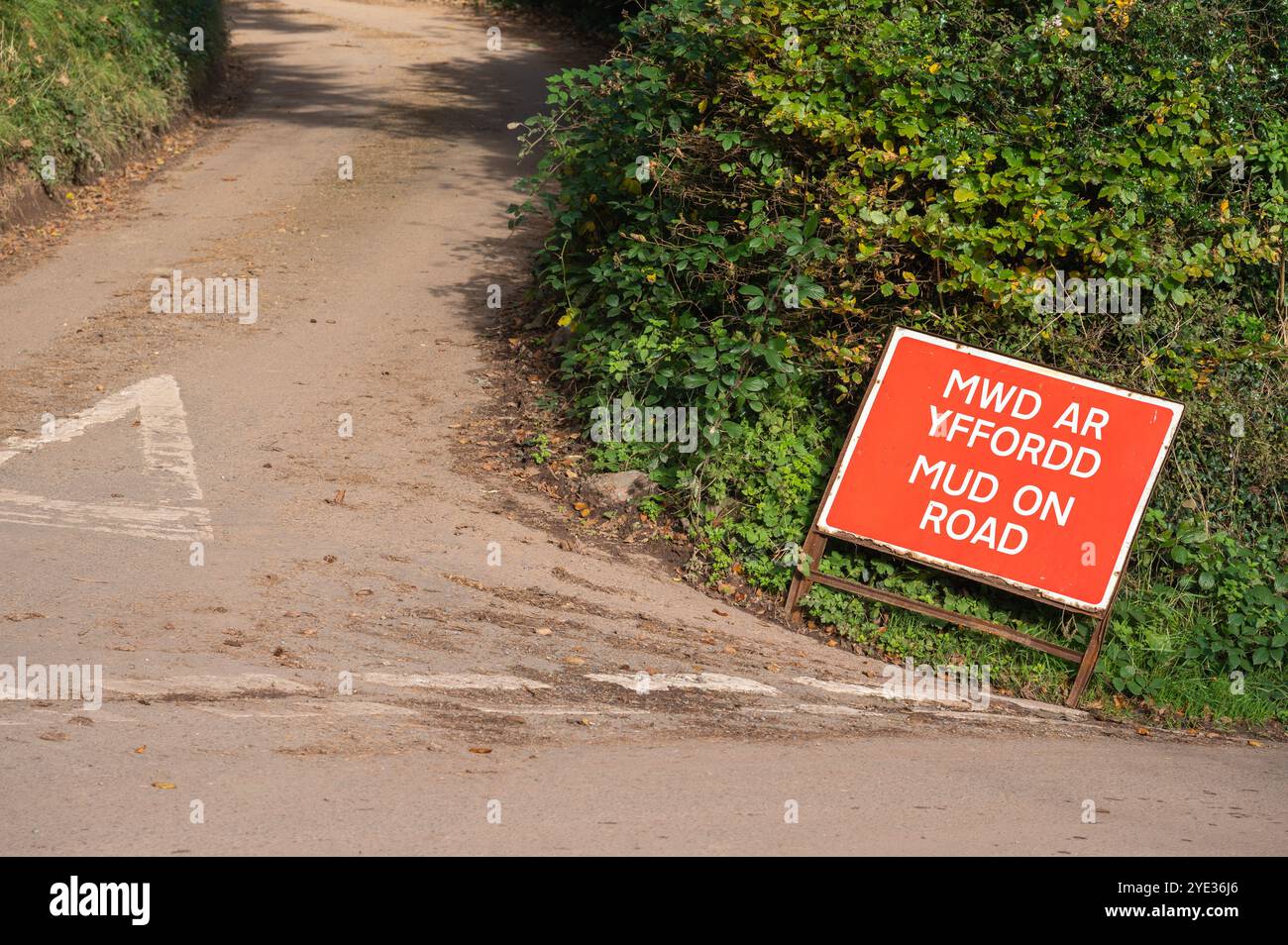 Sign warning of mud on road as a result of maize harvesting in wet ...