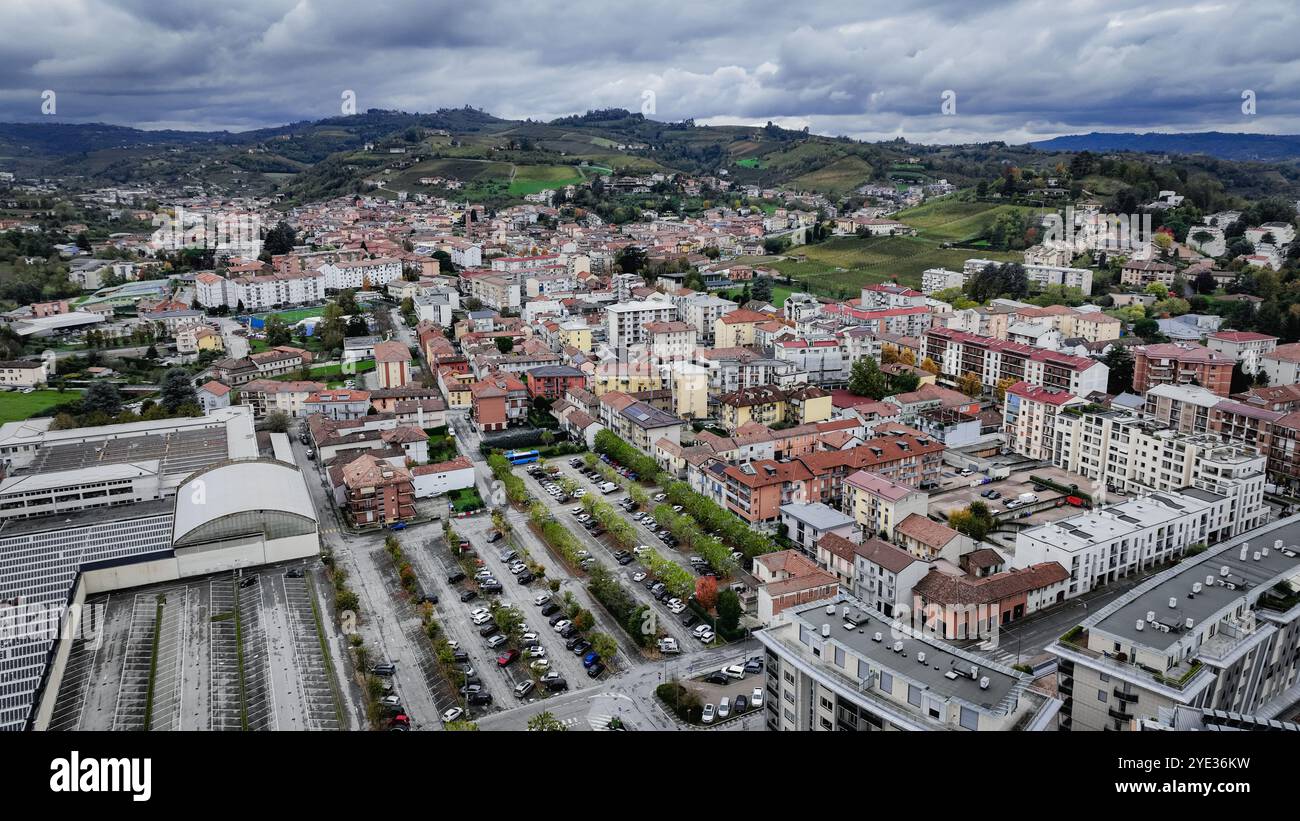 The charming town of Alba in Italy, set against rolling hills under a ...