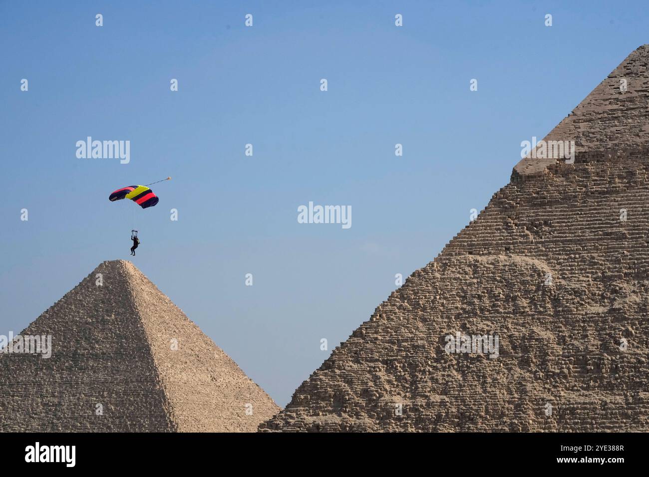 A skydiver parachutes at the historical site of Giza Pyramids, on the ...