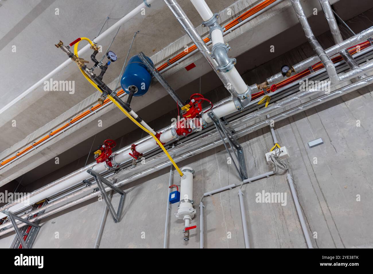 Complex industrial piping systems with valves, regulators, and safety ...