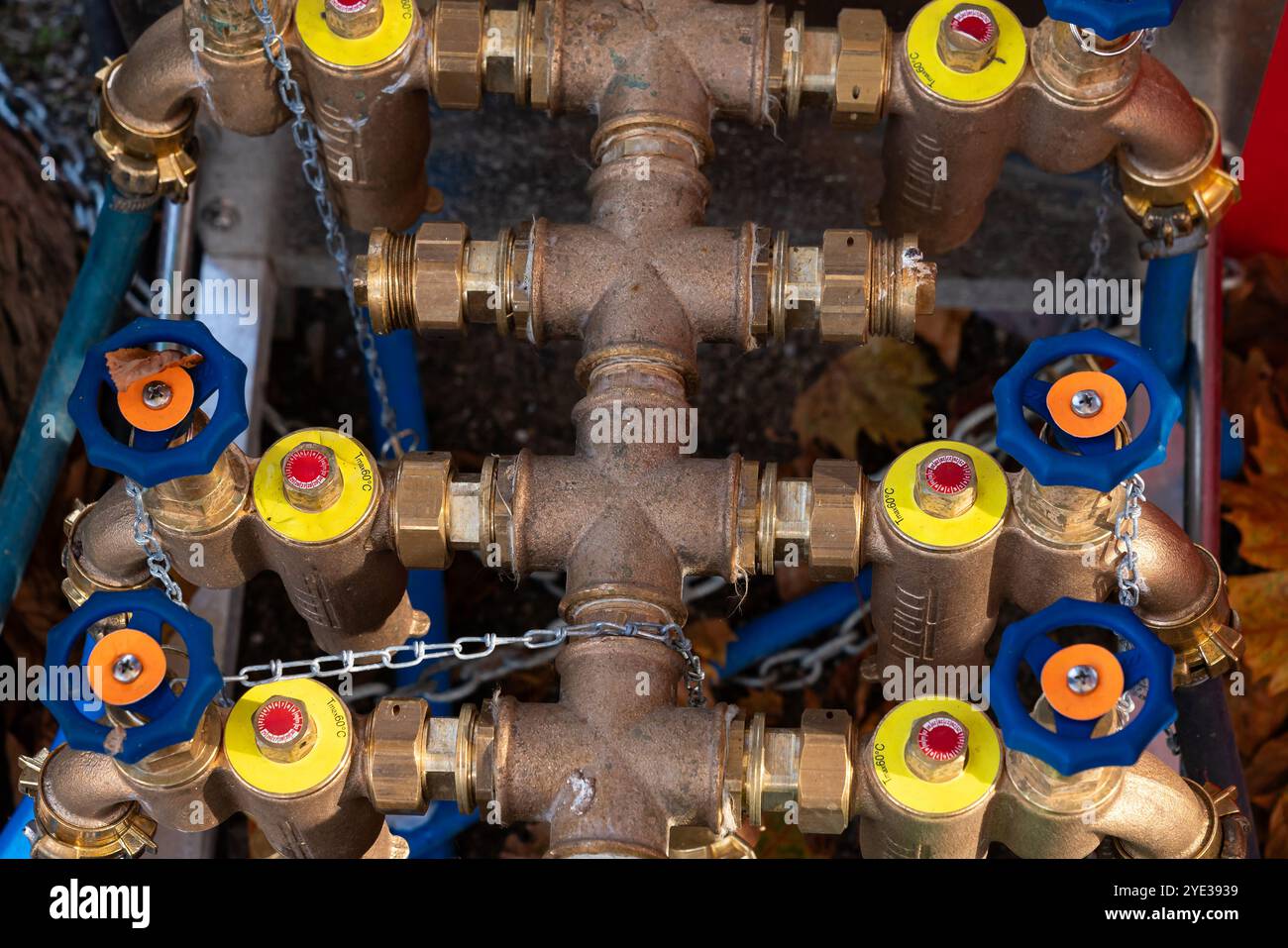 A detailed view of a complex plumbing system featuring multiple valves ...