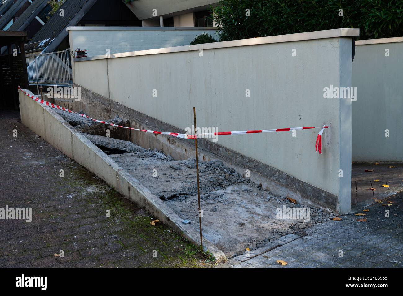 A pathway is under renovation, surrounded by safety barriers in a ...