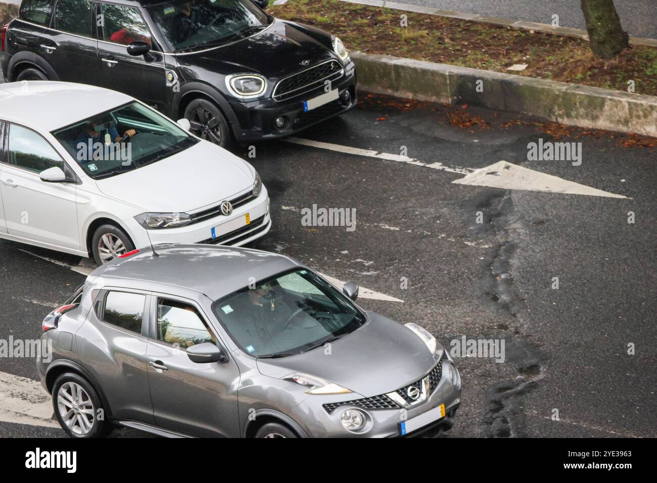 Cars driving on a multi lane city street, following the traffic flow ...