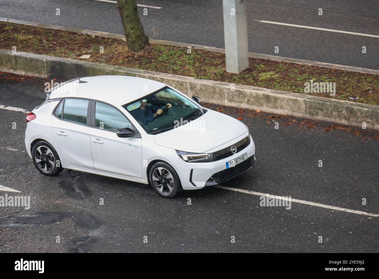 Man is driving a new white opel corsa on a multi lane road Stock Photo ...