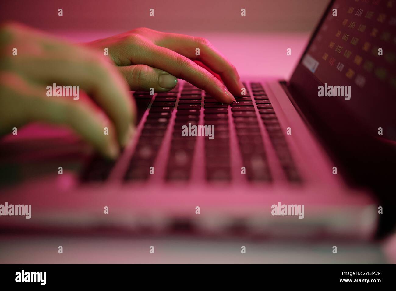 Typing on Laptop with Red Backlighting in Dark Room Stock Photo - Alamy