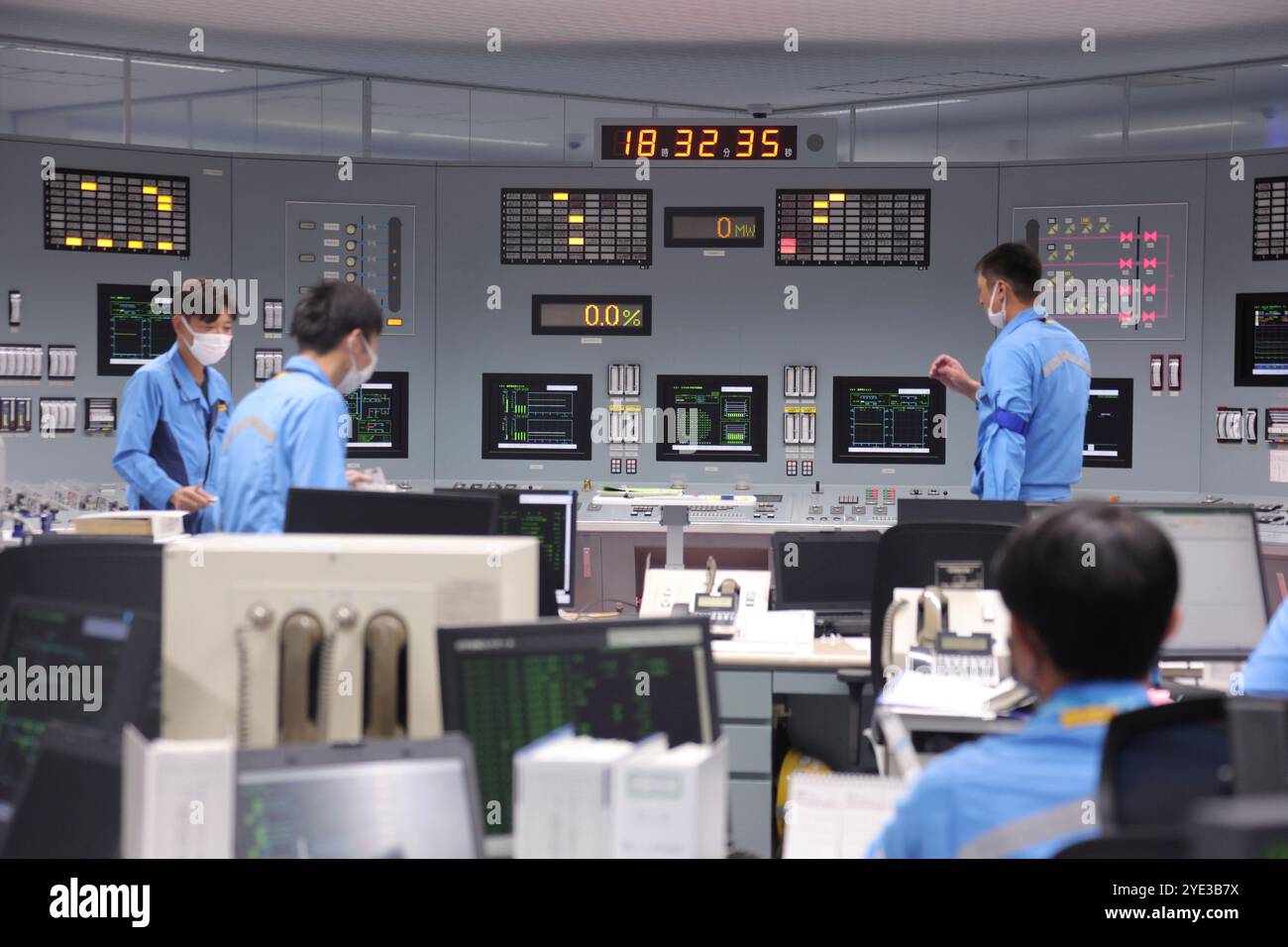 Operators start the reactor at the central control room of the Onagawa ...