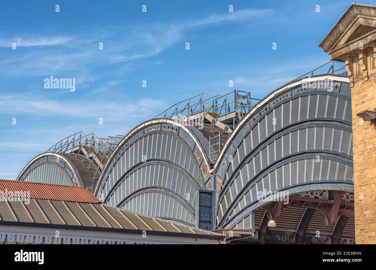 Three large historic arches of iron and glass form the entrance to a ...