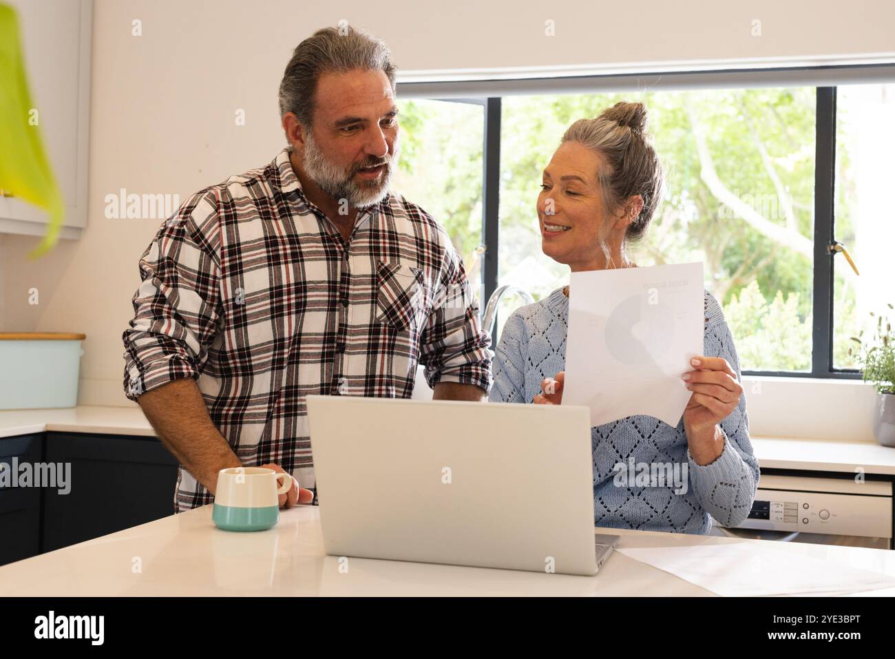 Mature couple discussing documents using hi-res stock photography and ...