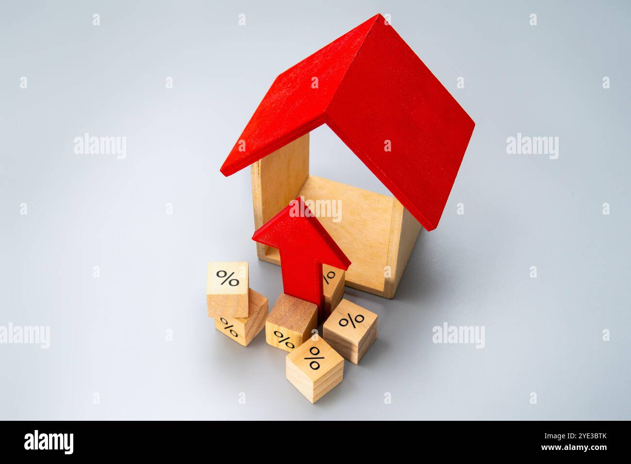 A house model with a upward pointing red arrow and blocks displaying ...