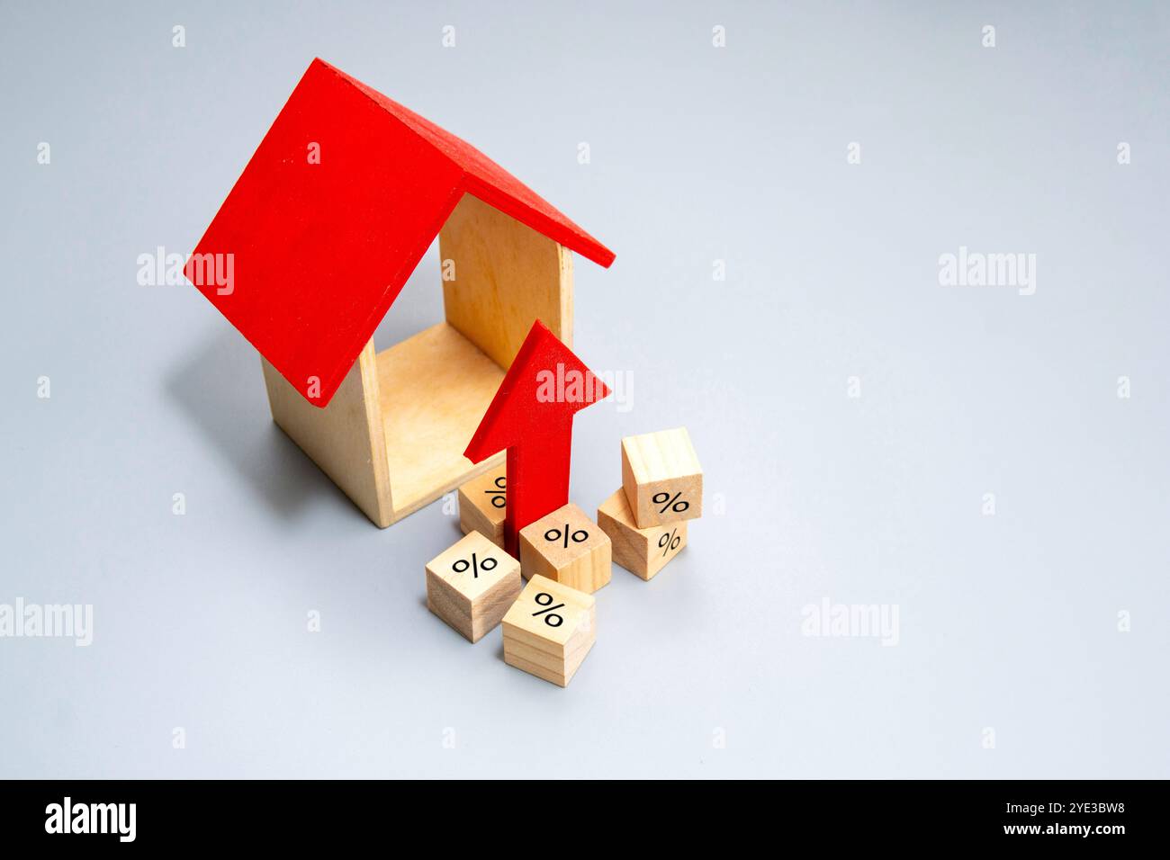 A house model with a upward pointing red arrow and blocks displaying ...