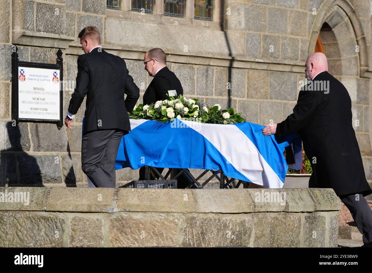 Pall bearers with the coffin, draped in a Saltire flag, arriving for ...