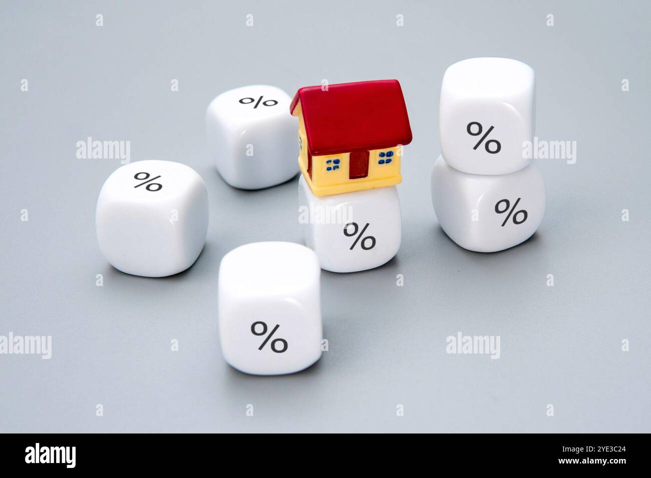 A small house surrounded by dice with percentage symbols. Property ...