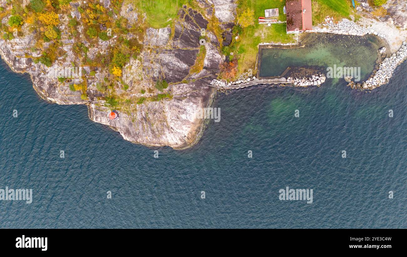 Aerial view of a coastal landscape with rocky shoreline, green ...