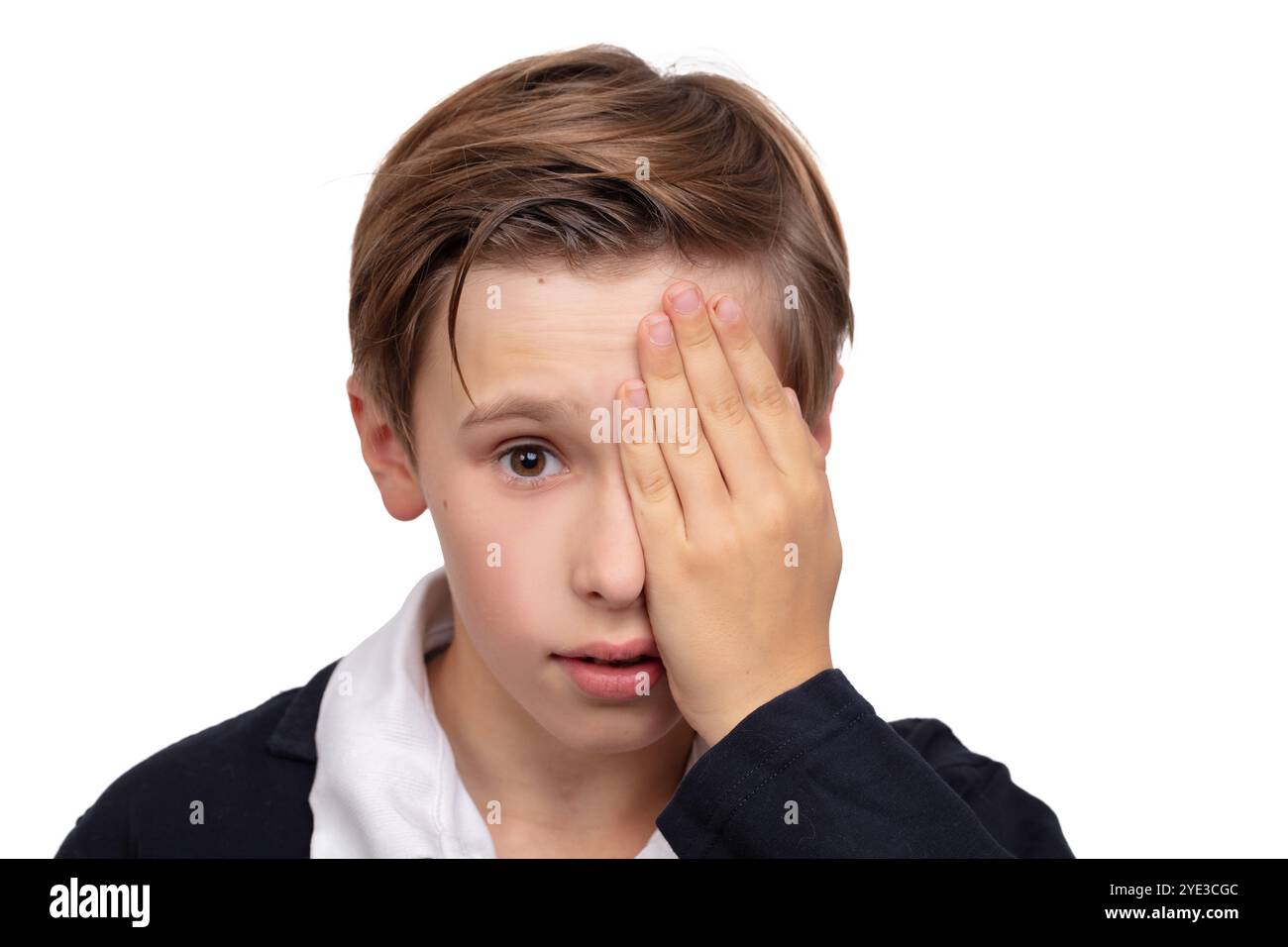 Portrait of a boy who covered one eye with his hand on a white ...