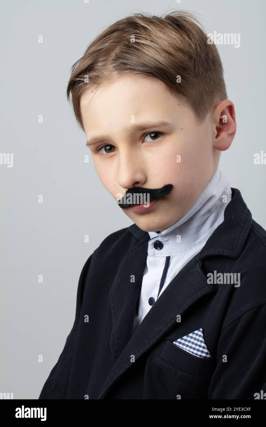 Portrait of a little boy with a mustache. A boy in the image of Nikola ...
