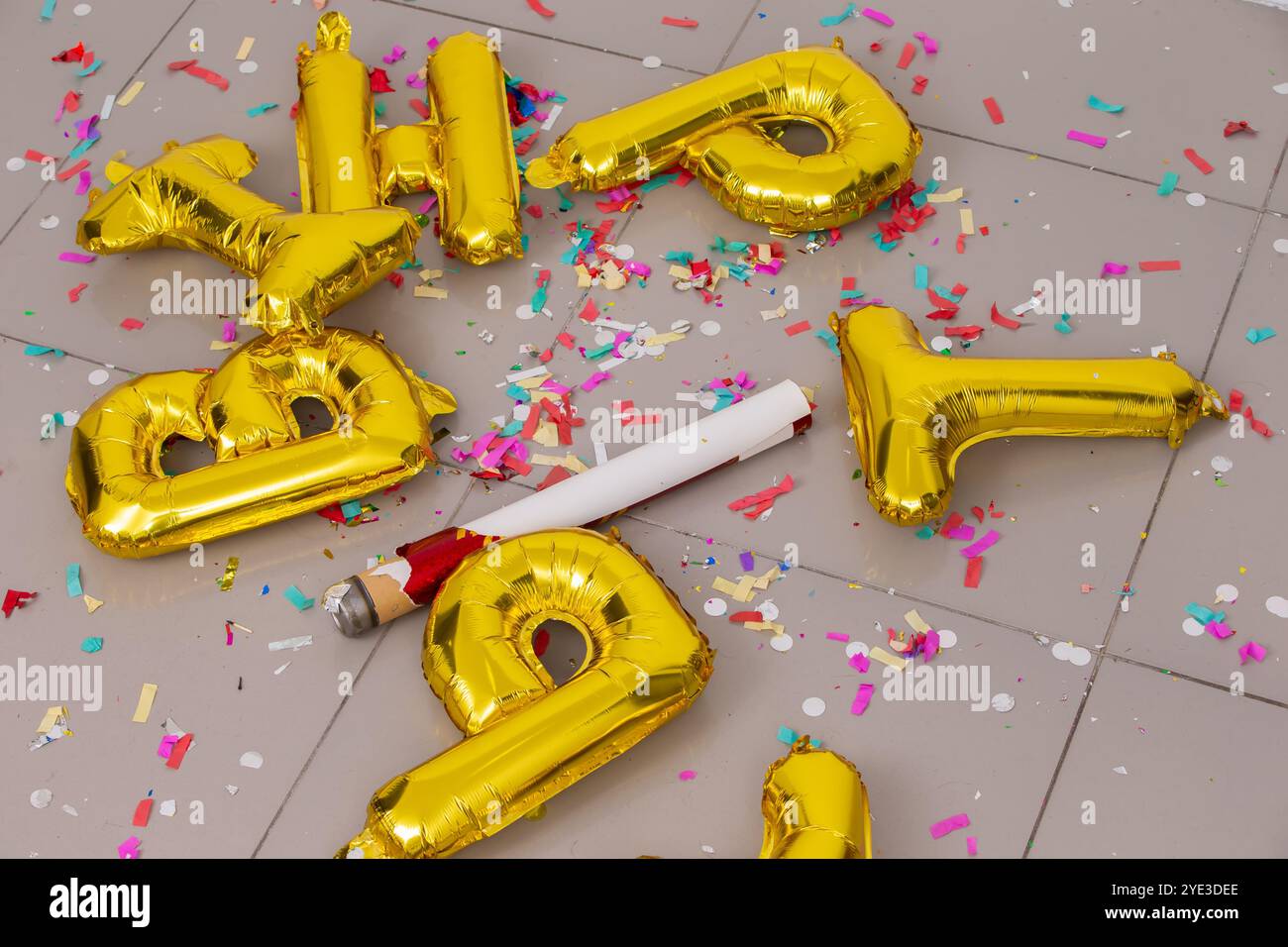 There are golden letter balls and an exploded confetti cracker on the ...