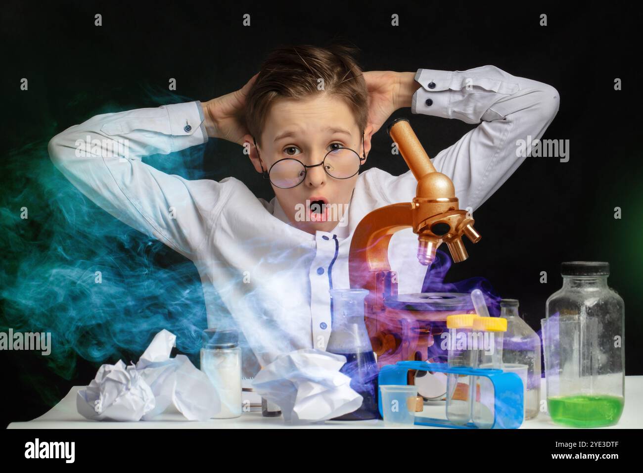 A boy scientist researcher with a microscope conducts experiments in ...