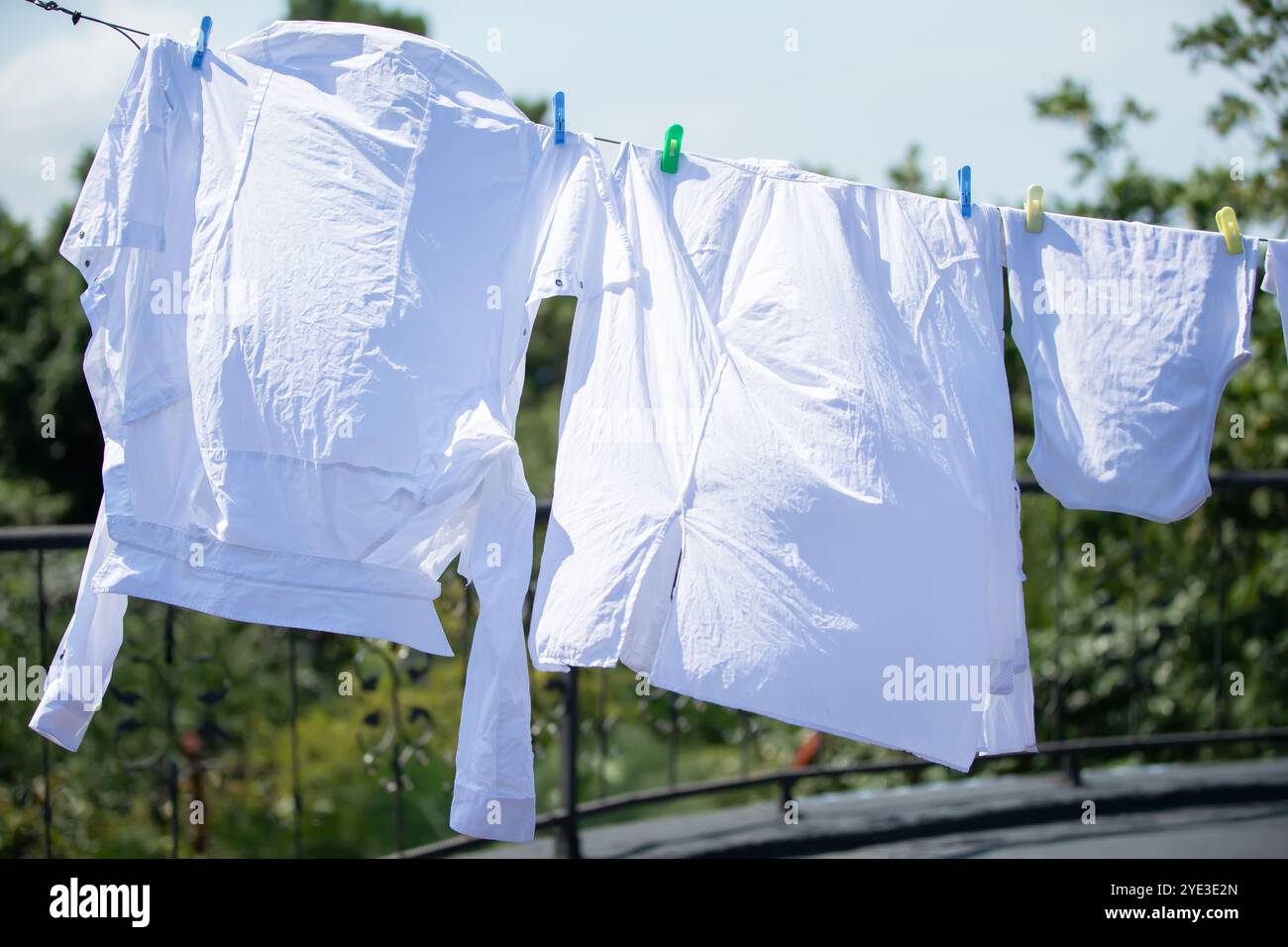 The white clothes are hung up and drying in the wind Stock Photo - Alamy