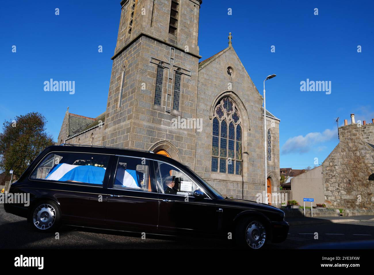 The hearse carrying the coffin, draped in a Saltire flag, arrives for ...