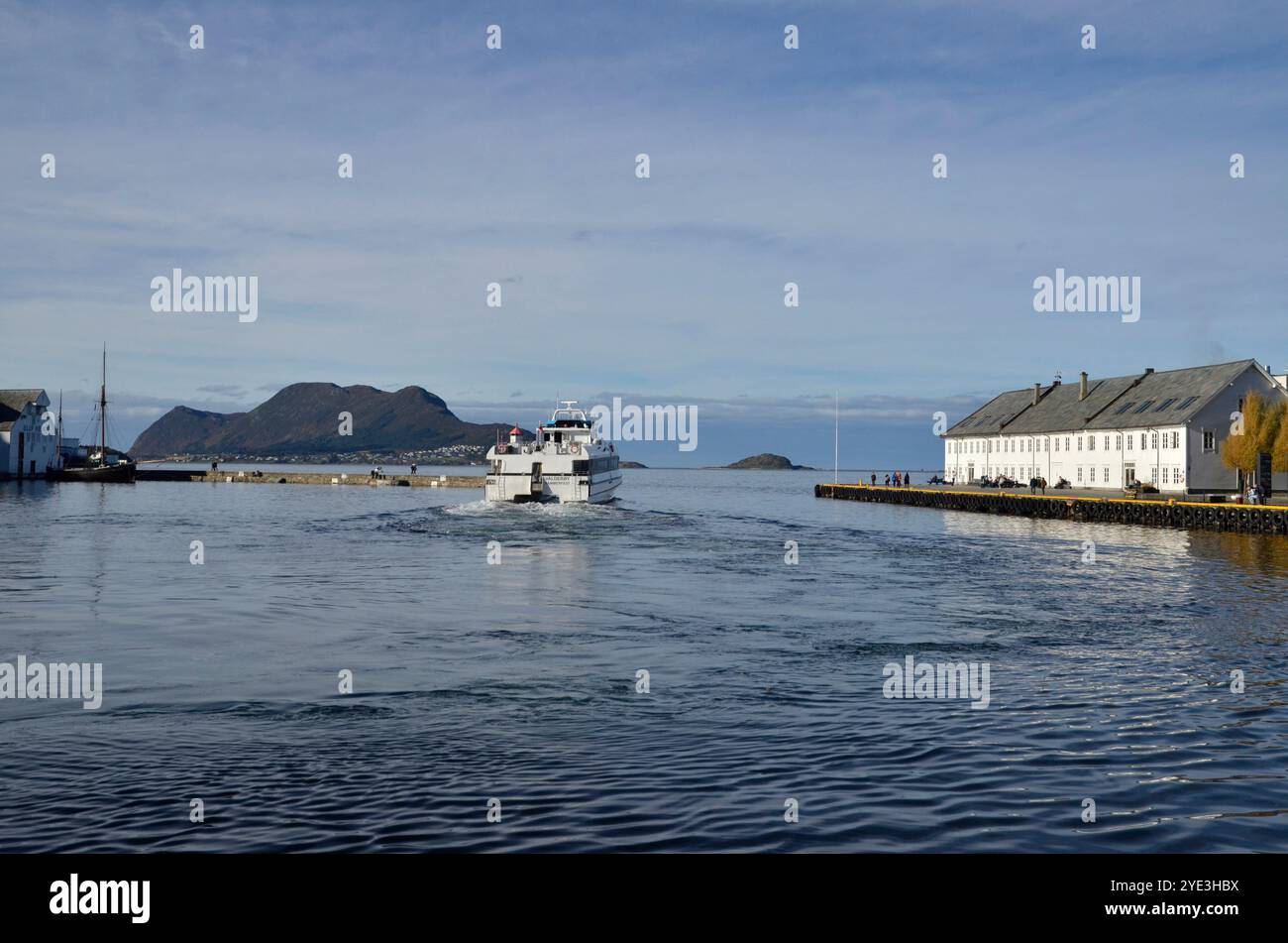 A catamaran ferry leaving the main harbour in the Norwegian town of ...