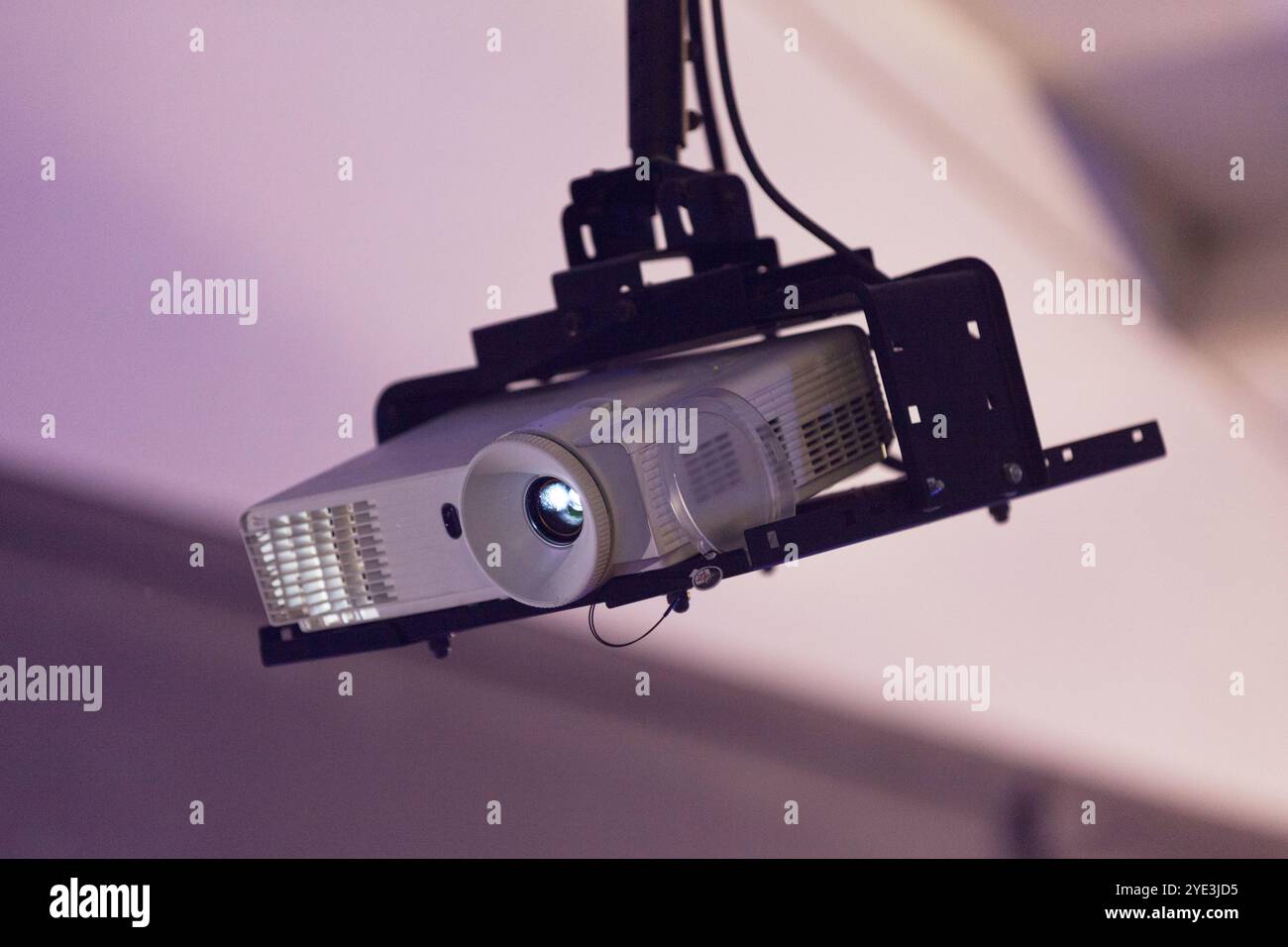 Digital projector attached to the ceiling of a conference room of an ...