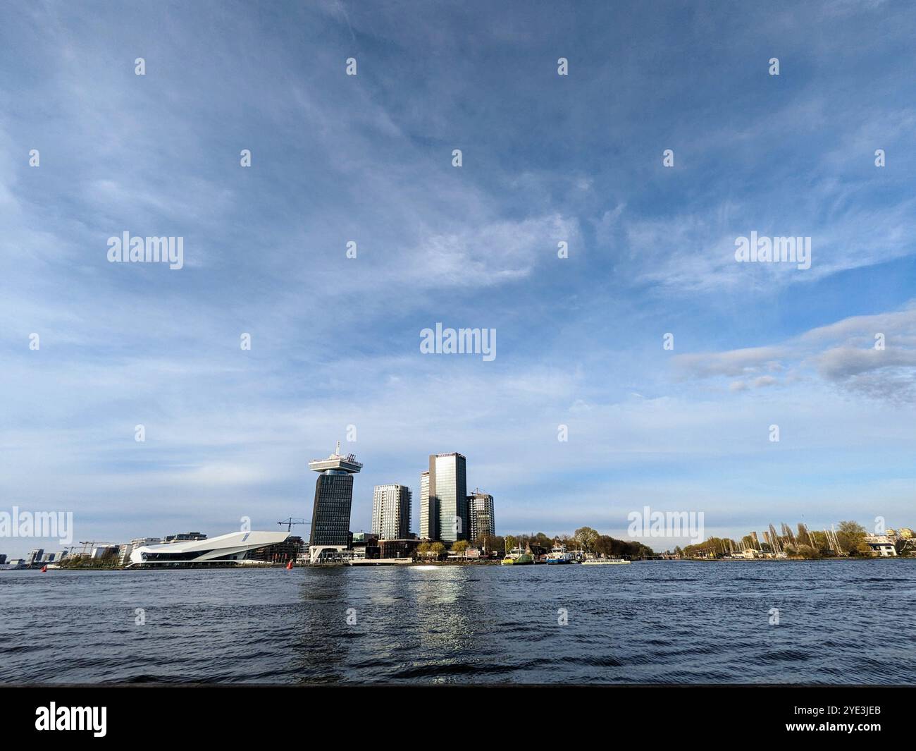 A stunning city skyline beautifully reflects on calm waters beneath a ...