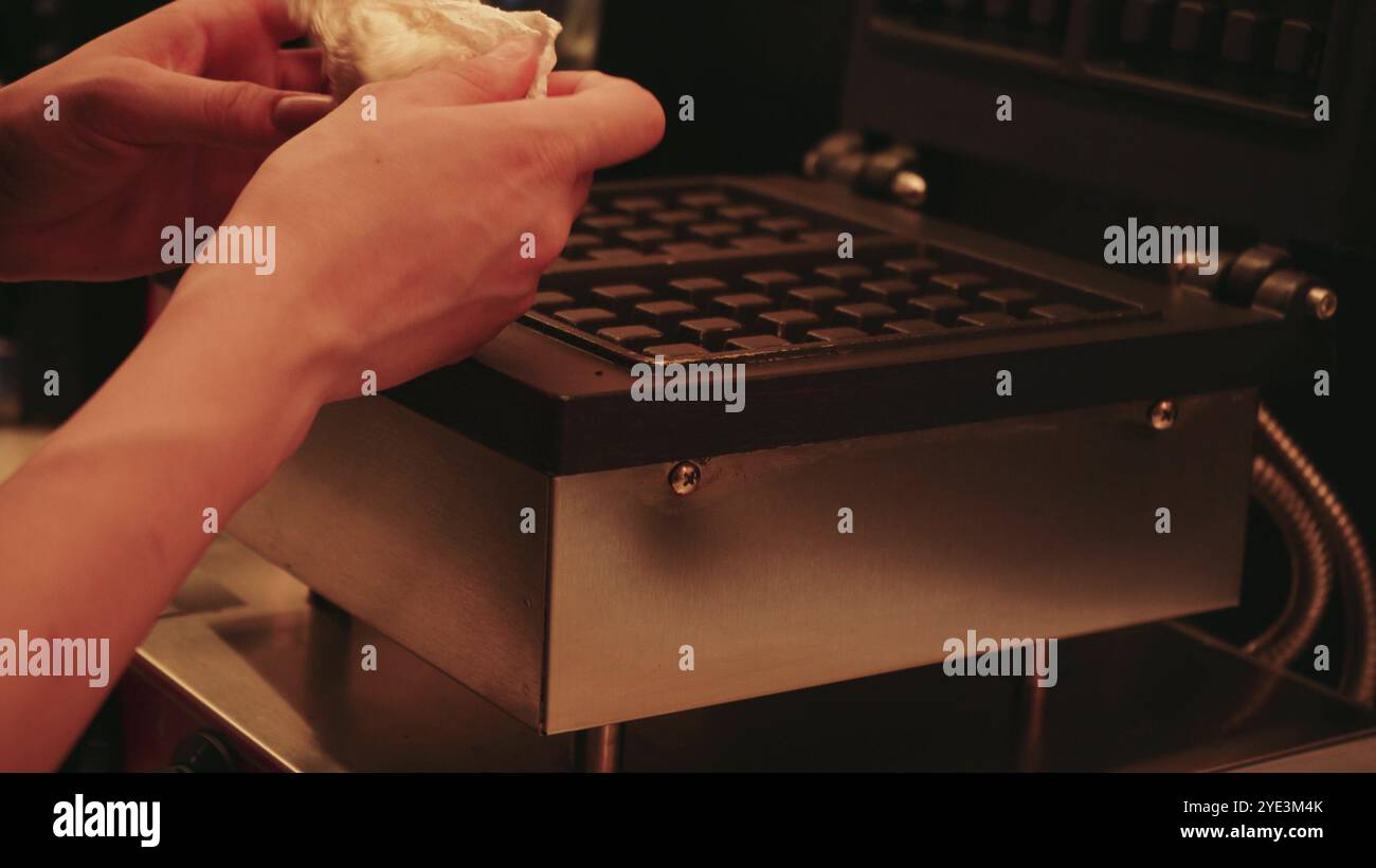 A woman cleans and washes tools after cooking. The process of finishing ...