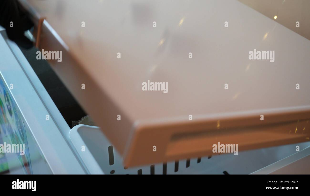 The process of opening the freezer lid. A freezer in an industrial ...