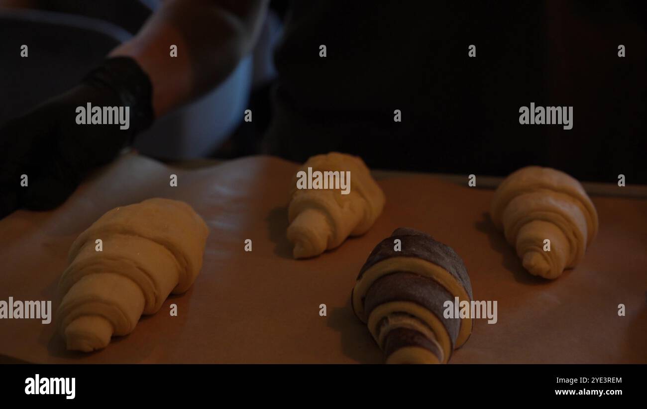Croissants bake inside the oven, puffing up with a golden finish. A ...