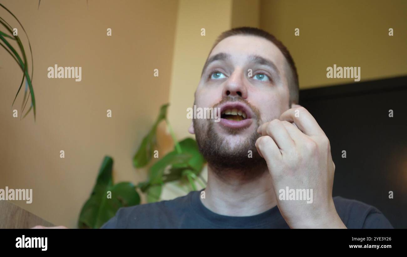 A man tears into a warm croissant, enjoying the smell and taste. The ...