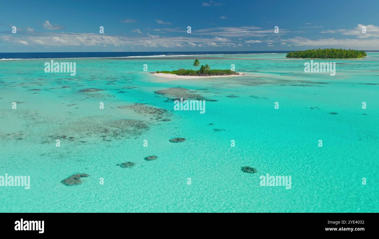 Aerial view of a tiny tropical French Polynesia island surrounded by ...