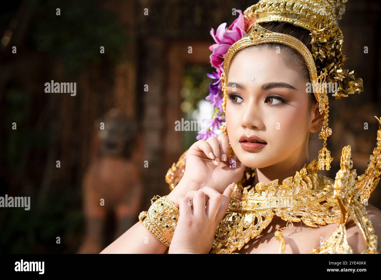A model in traditional Thai attire poses against a historic Sukhothai ...