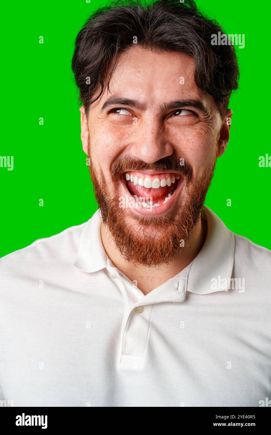 A man with a beard smiles confidently against a bright green background ...