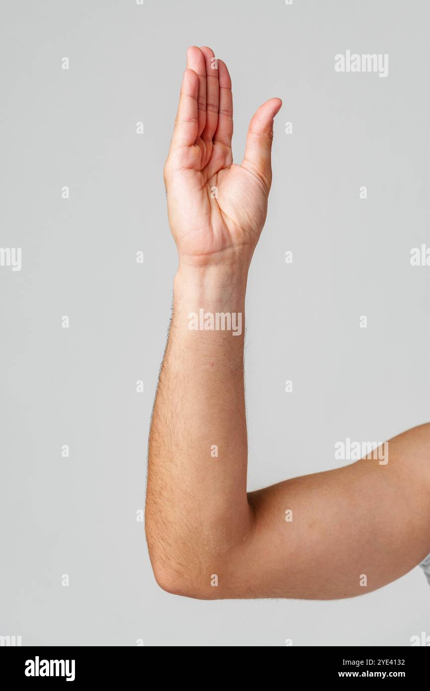 A person hand gesture against a neutral background Stock Photo - Alamy