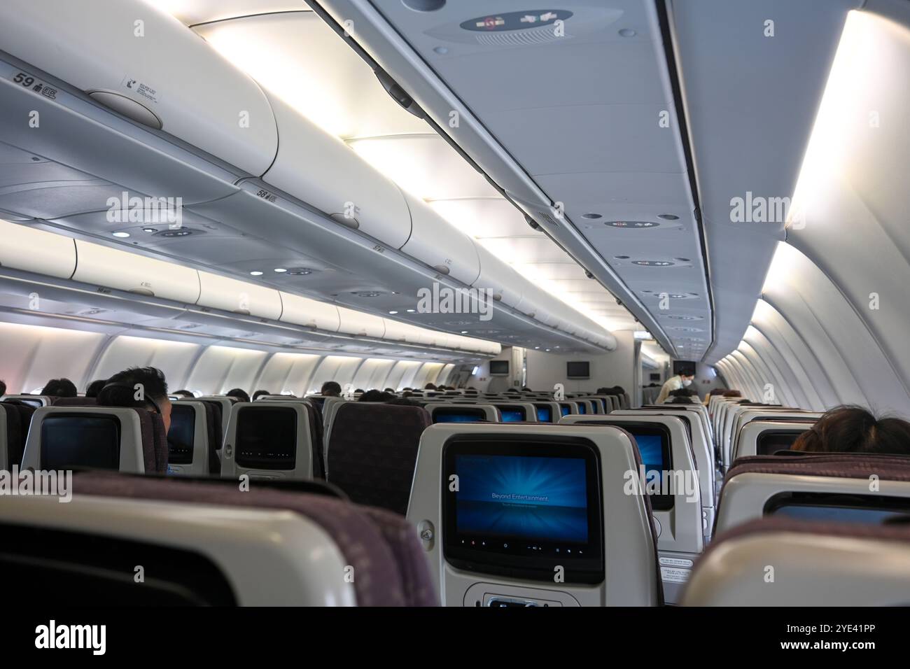 Inside view of a Korean Air cabin with seatback entertainment and ...