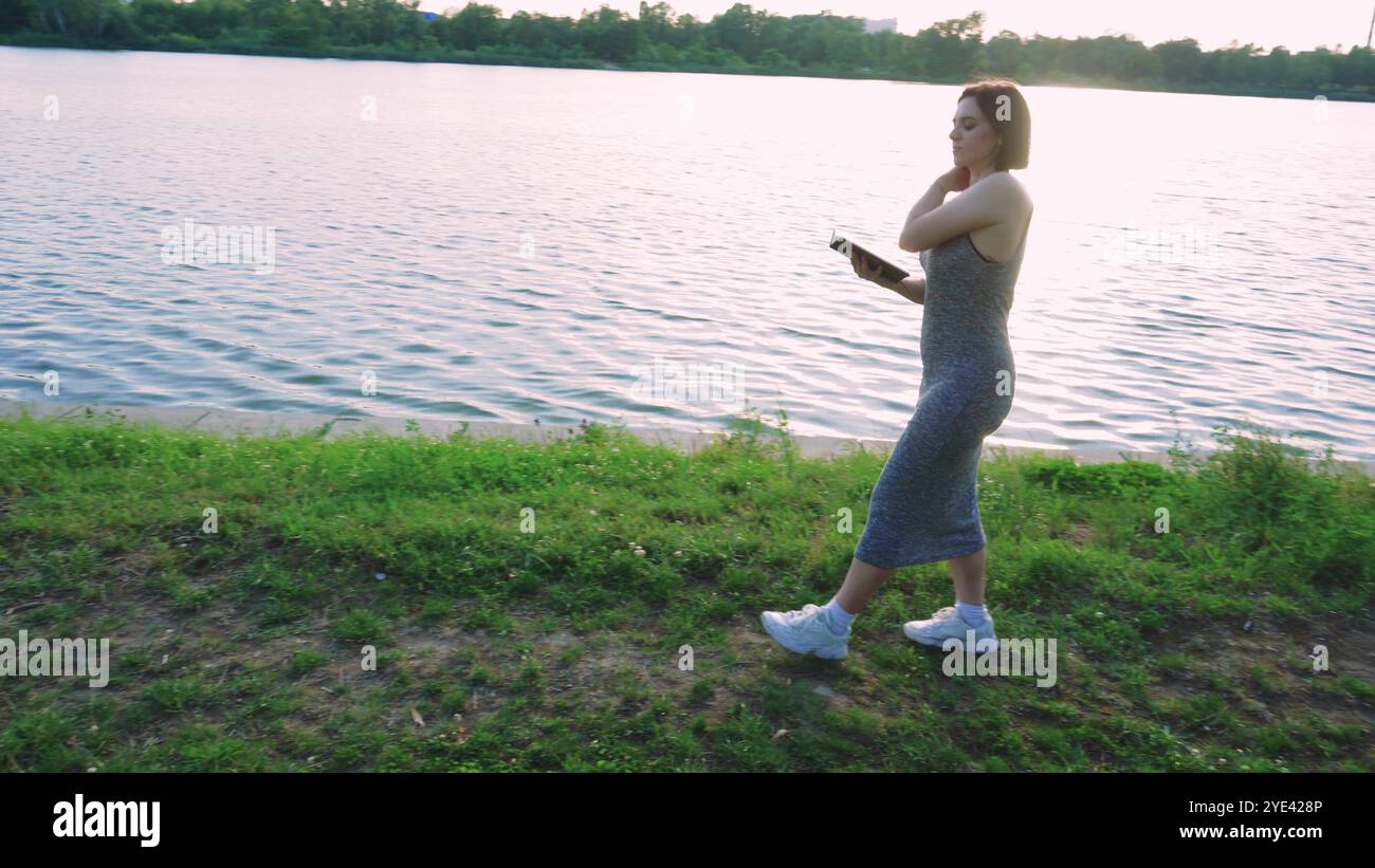 Woman enjoying river scene sunset hi-res stock photography and images ...