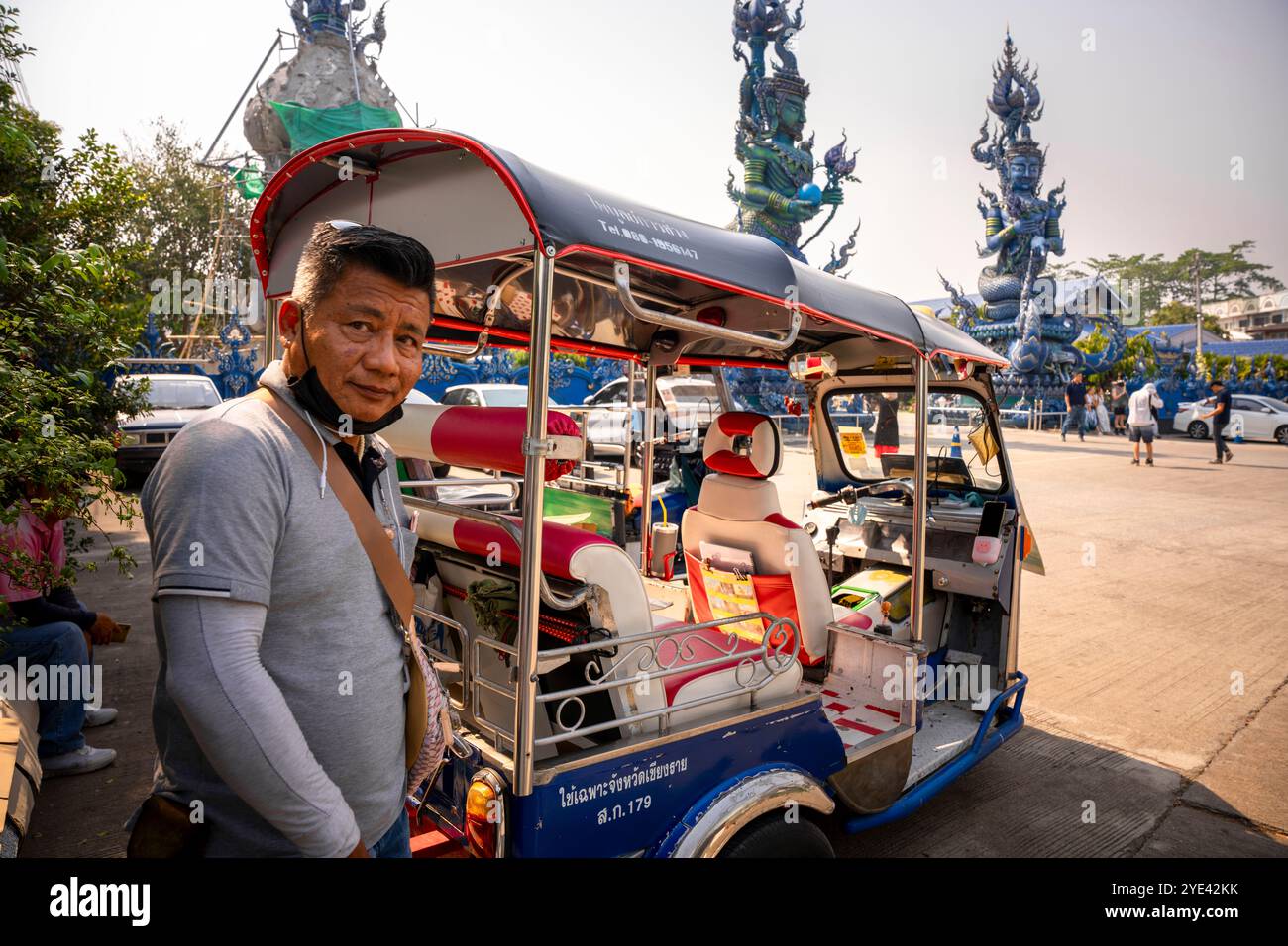 A tuk-tuk driver waits for passengers outside the iconic Blue Temple in ...
