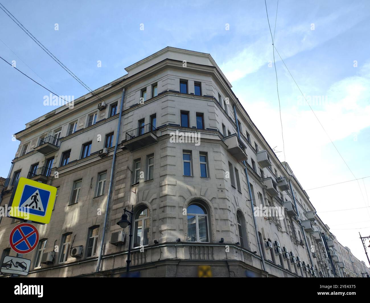 large yellow building with multiple windows and an arched doorway ...