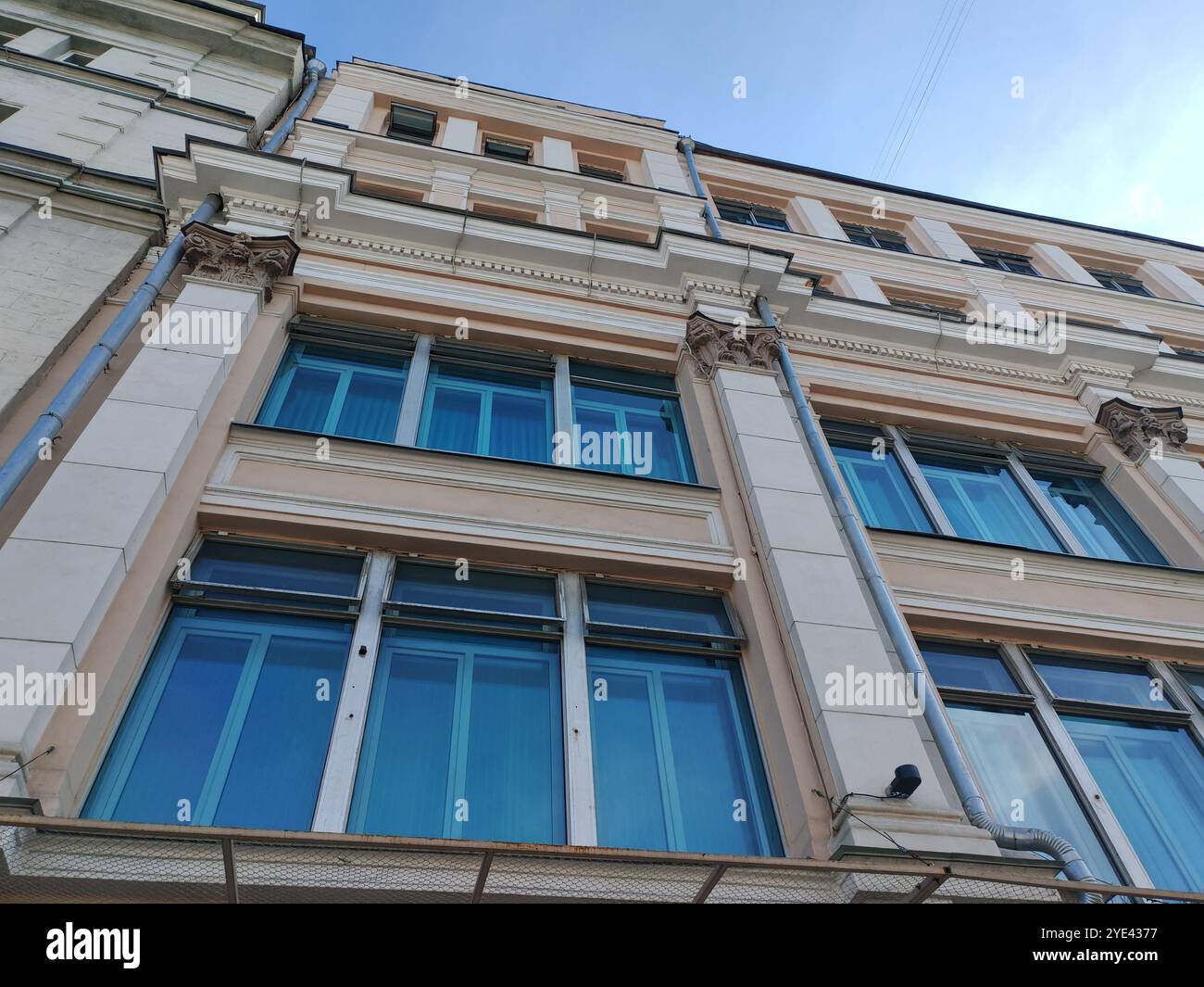 grand yellow building with symmetrical windows and classical detailing ...