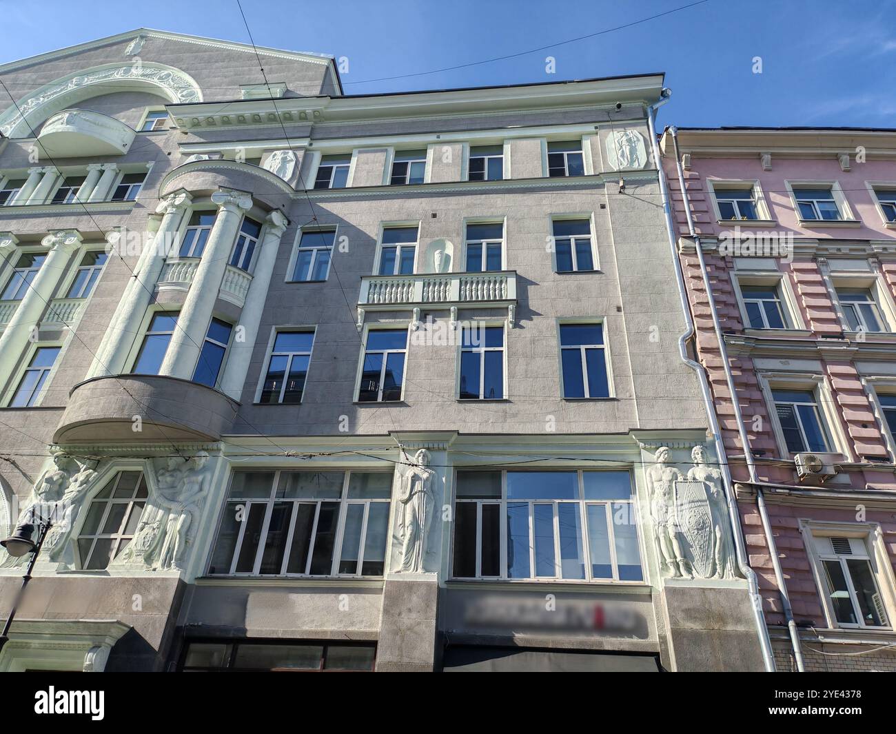 grand yellow building with symmetrical windows and classical detailing ...